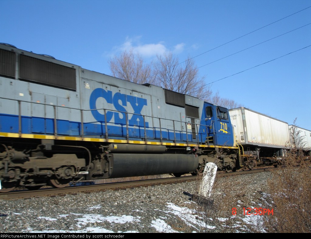 CSX 710 runs backwards past a private road crossing WB